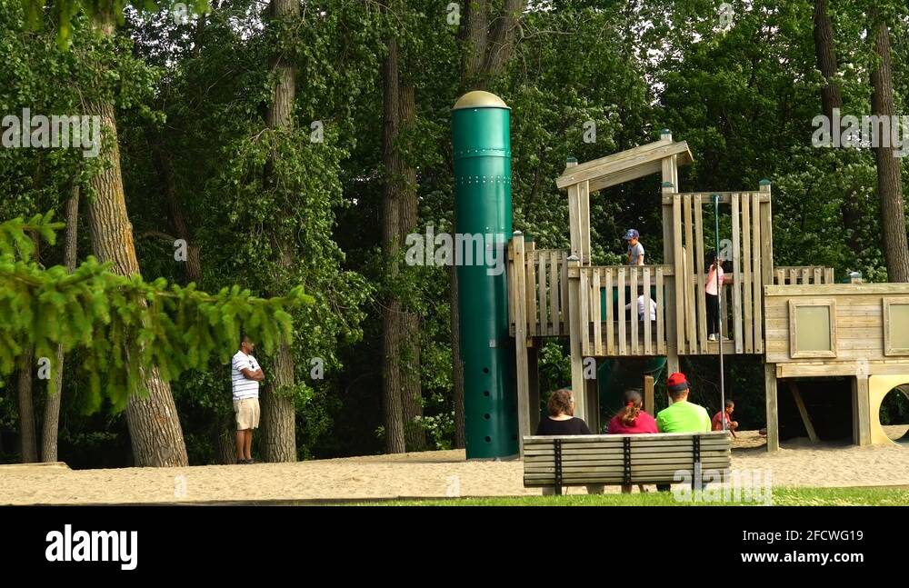 Cinematic shot of kids playing at a small Park during a summer day ...