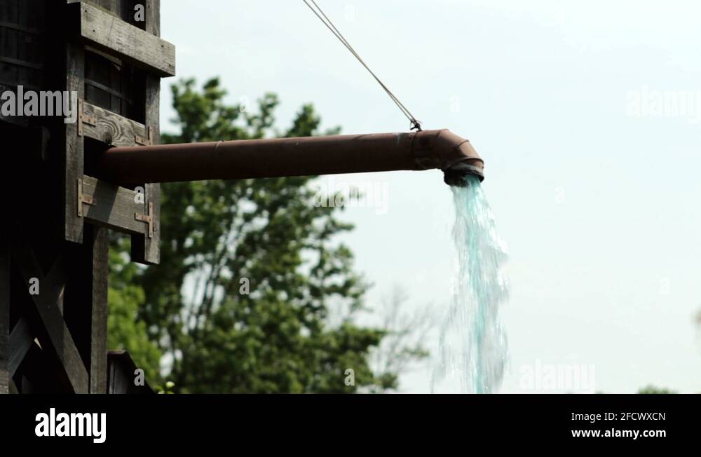 Spigot pouring from water tank on farm Stock Video Footage - Alamy