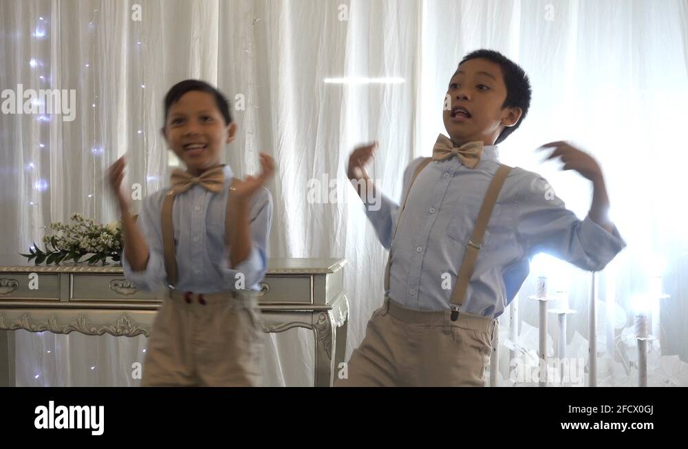 Happy asian kids dancing the viral floss dance together wearing ...