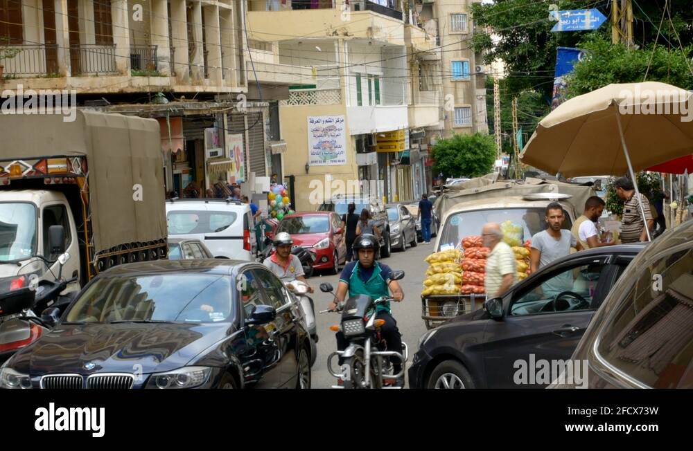 Busy street view with people, cars and motorbike traffic Stock Video ...