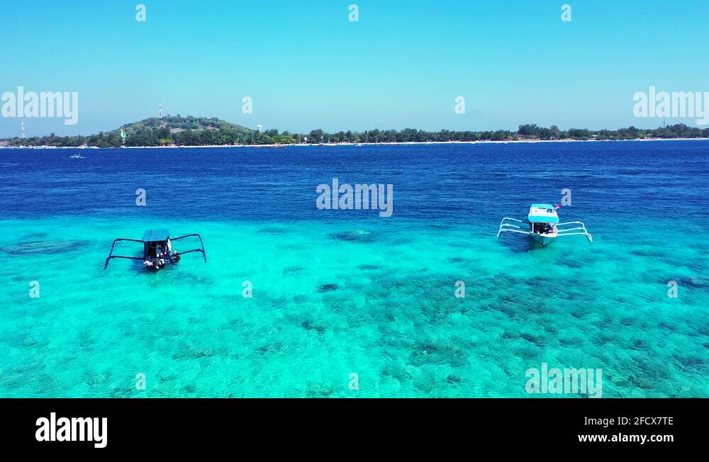 Traditional Indonesian wood boats floating on clear calm seawater of ...