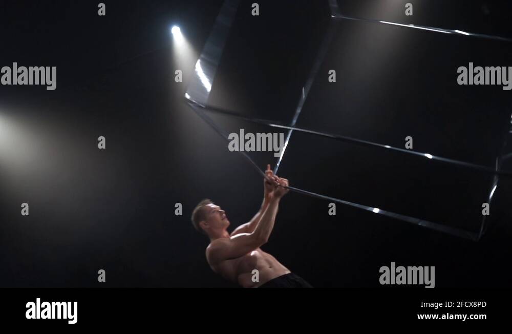 circus male muscular performer making tricks with juggling cube props ...