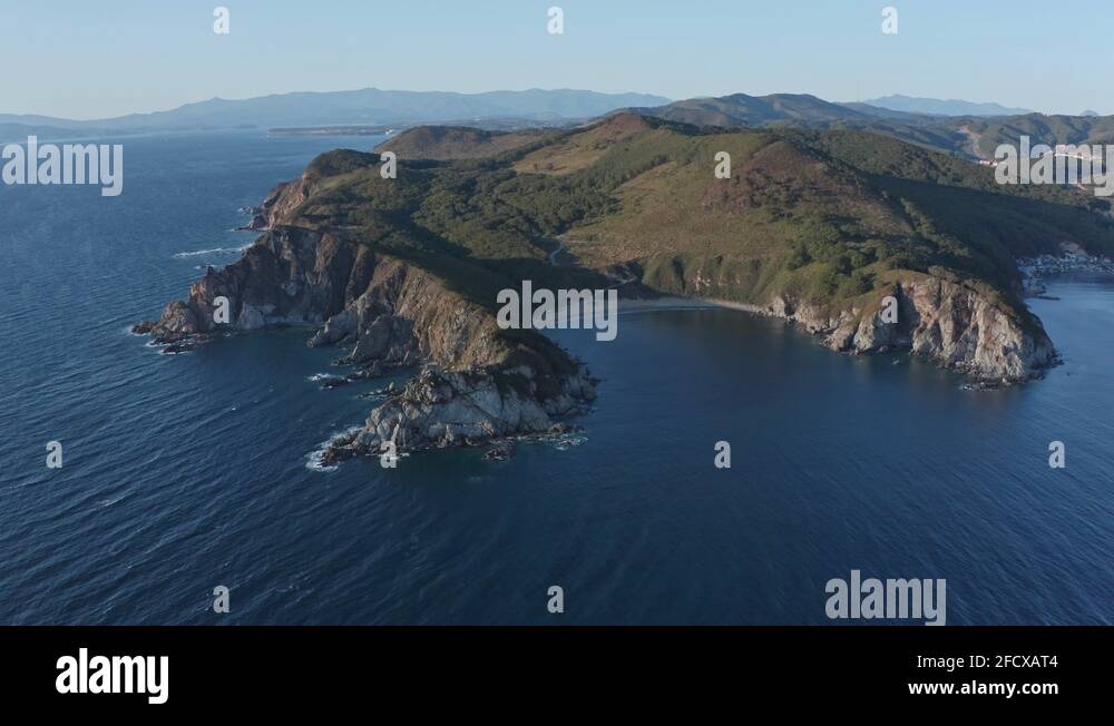 Bird's eye view of coastline with steep cliffs and sandy beach bay and ...