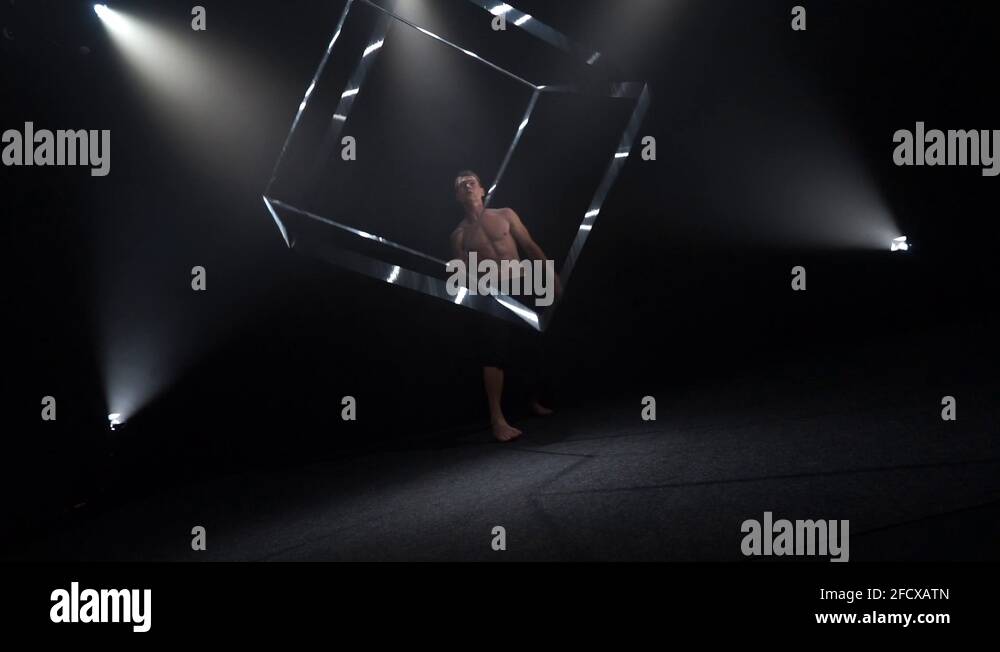 circus male muscular performer making tricks with juggling cube props ...