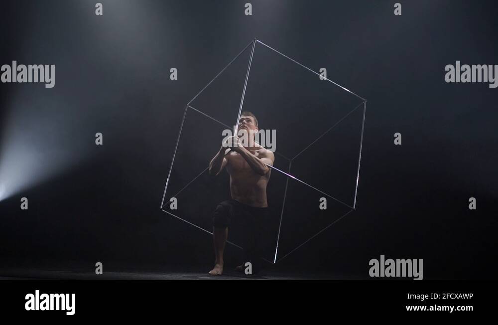 circus male muscular performer making tricks with juggling cube props ...