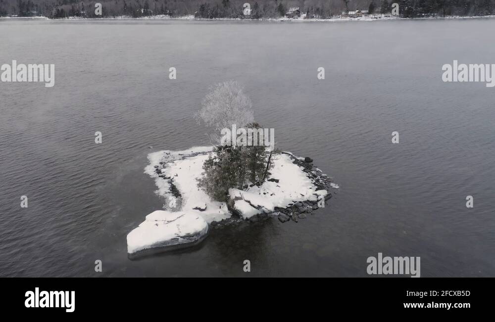 Snow covered island on lake Aerial Stock Video Footage - Alamy