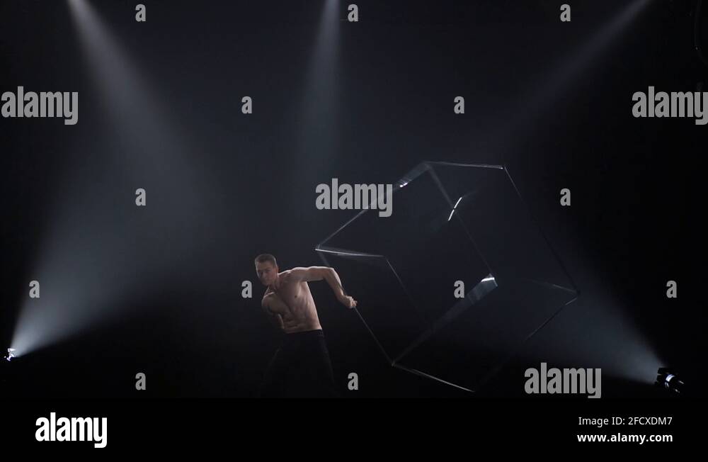 circus male muscular performer making tricks with juggling cube props ...
