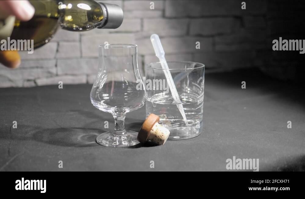 Pouring a dram of Whisky (Caol Ila) into a Nosing Glas next to ...