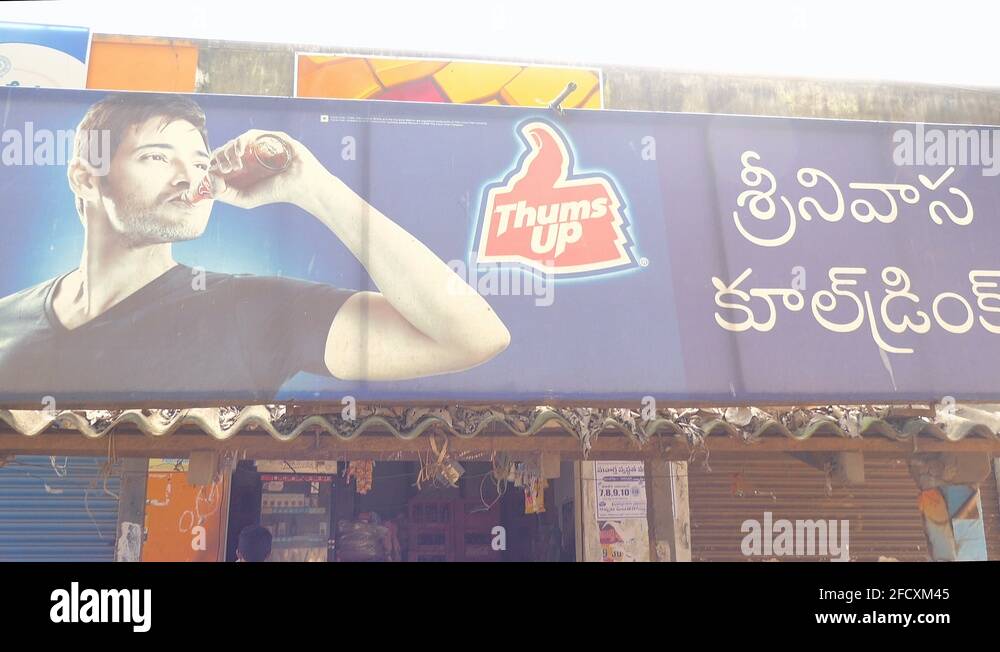 Tilt down. from Thumbs-up ad with young male model drinking from a ...