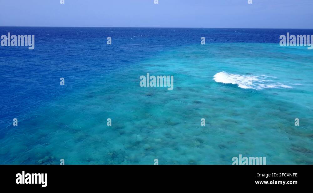 Blue turquoise sea water whites by waves splashing on coral reefs and ...