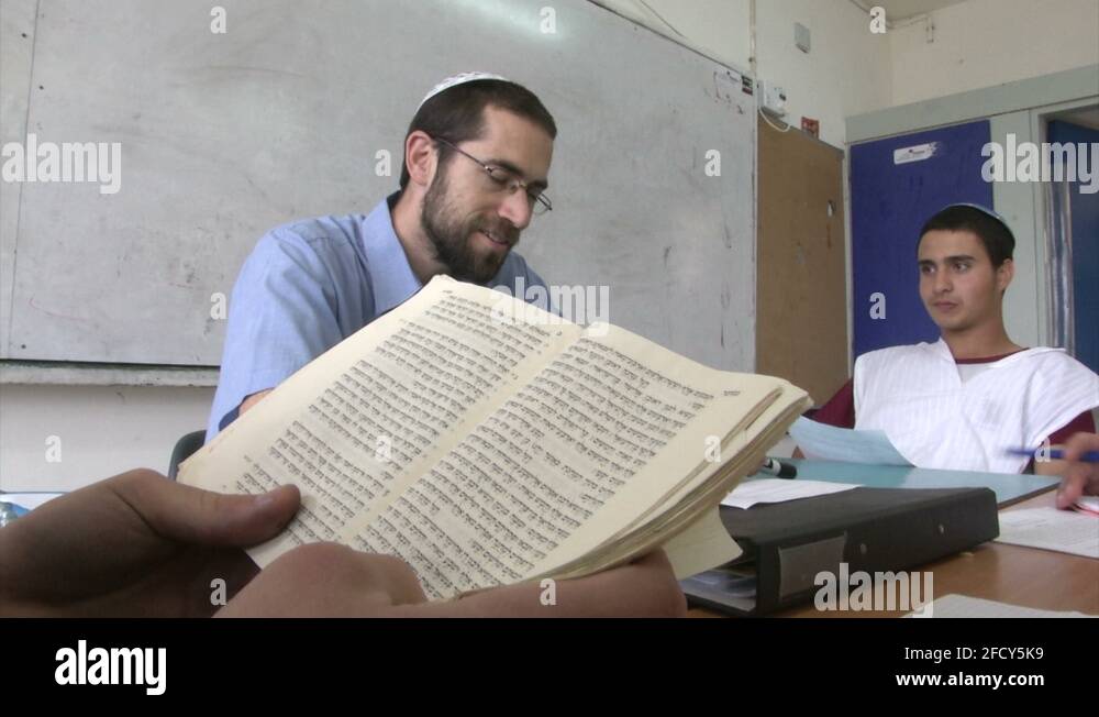 Teacher gives a Torah lesson to class inside of a religious school in ...