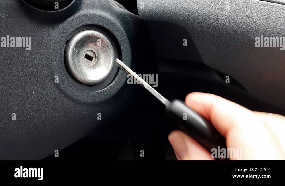 Starting the engine of a car: the key is inserted into the dashboard ...