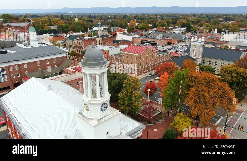 Historic colonial style building with clock tower and red brick facade ...