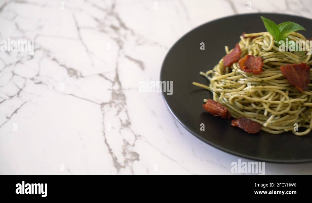 Spaghetti with basil pesto and bacon Stock Video Footage - Alamy
