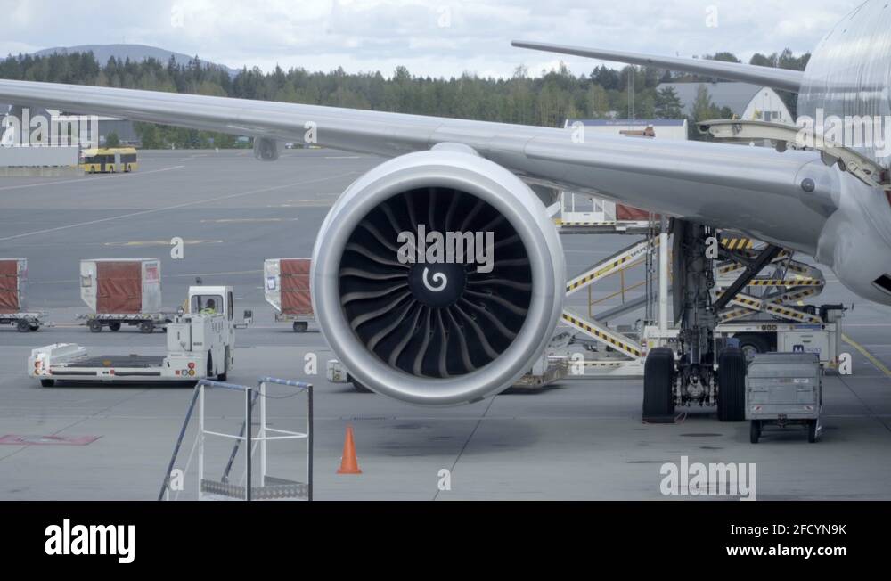 Close Up of Airplane Jet Turbine Spinning While Plane is Parked at ...