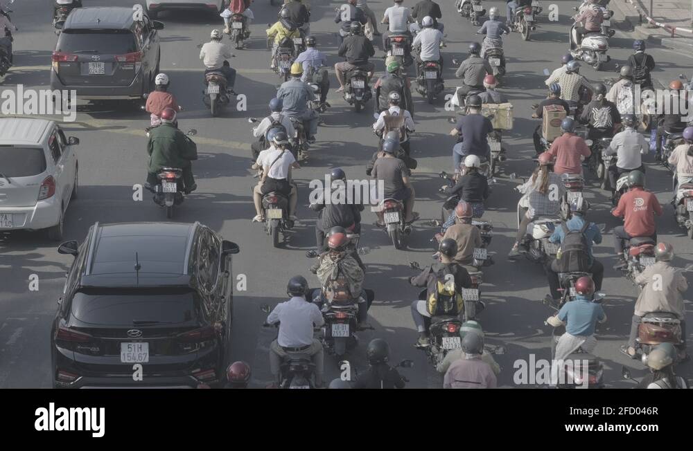 Slow moving traffic with lots of motorbike, bus, motorcycles, car ...