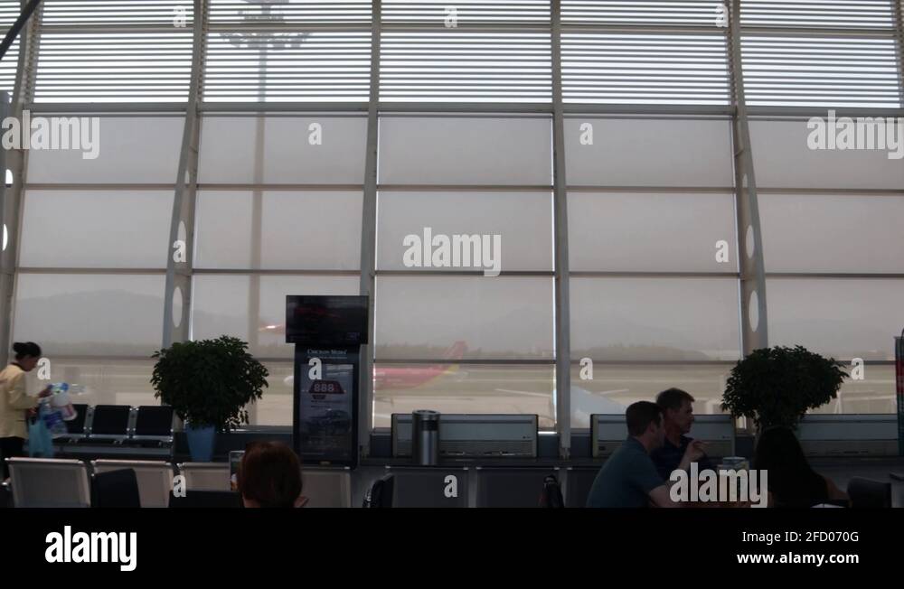 Take-off airplane view through an airport window in a waiting room ...