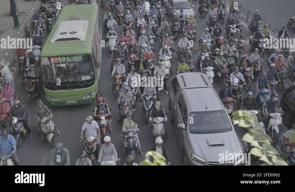 Slow moving traffic with lots of motorbike, bus, motorcycles, car ...