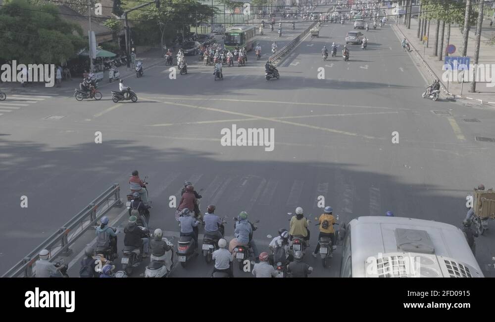 Slow moving traffic with lots of motorbike, bus, motorcycles, car ...