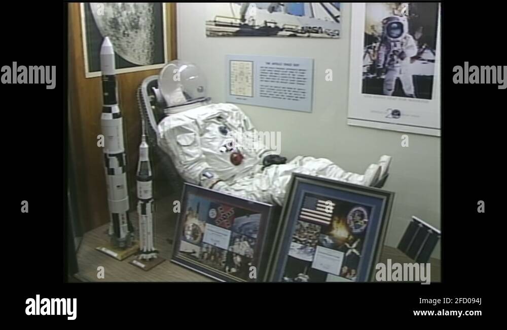 1990s: Space suit and capsule on display in museum. Children work at ...
