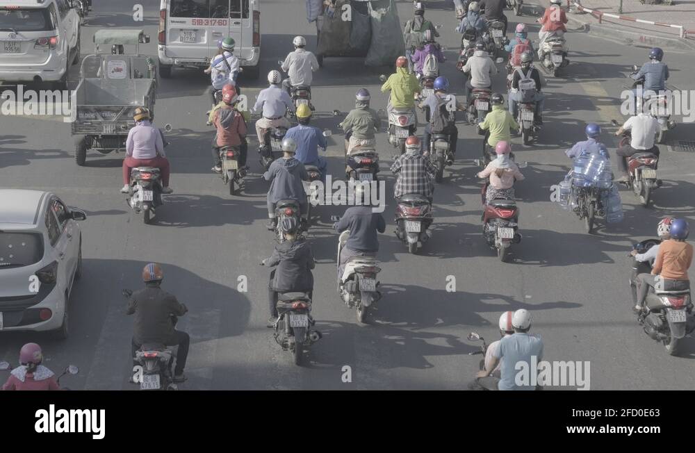 Slow moving traffic with lots of motorbike, bus, motorcycles, car ...