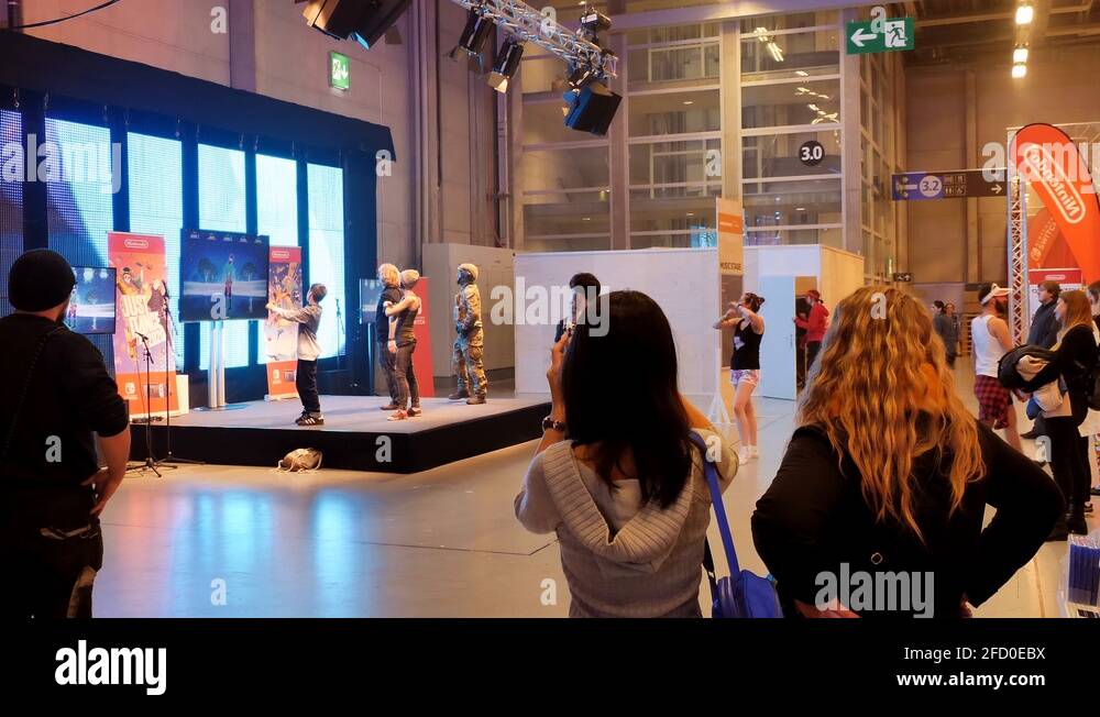 two young women are filming a lets dance competition with their mobile ...