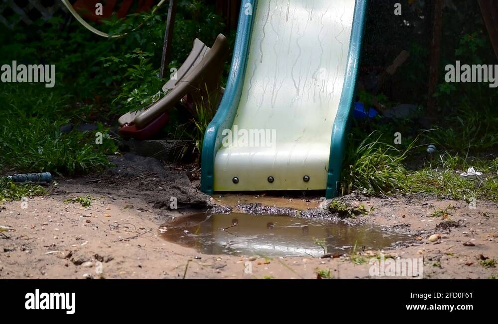 4k handheld summer fun with kids sliding and jumping into mud puddle ...