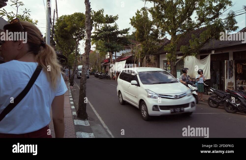 Filming beautiful crowded streets in Ubud Bali Indonesia, tourist Stock ...