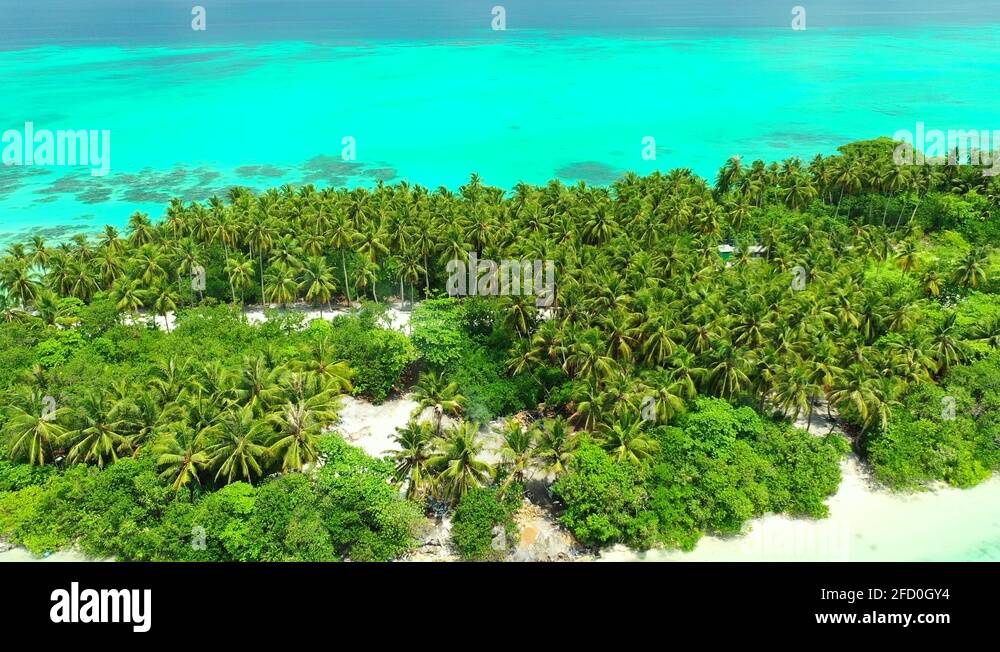 Bright azure lagoon with calm water over coral reefs and rocky seabed ...