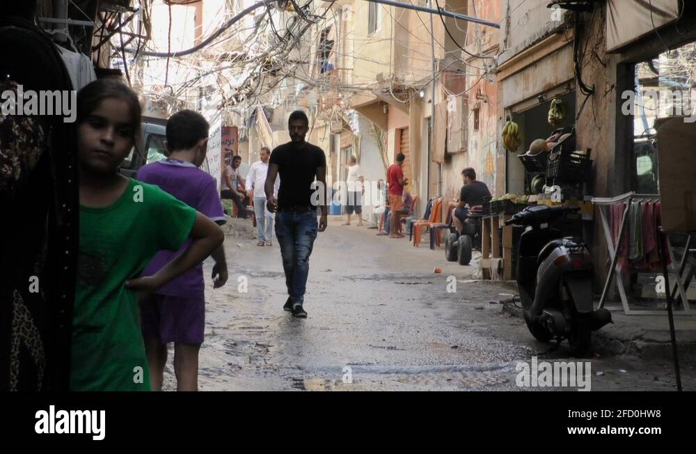 Palestinians walk in an alleyway at Burj Al - Barajneh Palestinian ...