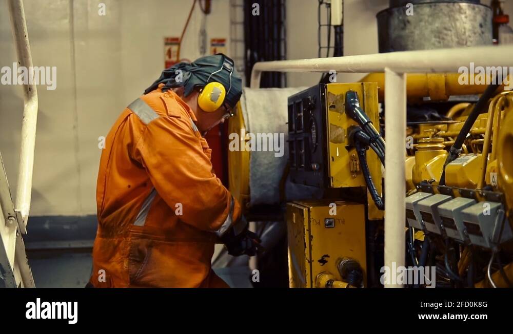 Marine engineer inspecting ship's engine in engine control room Stock ...