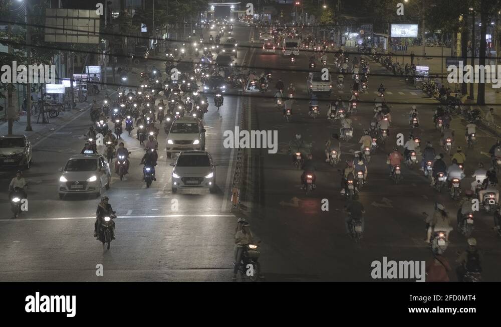 Slow moving traffic with lots of motorbikes, car... transport at night ...