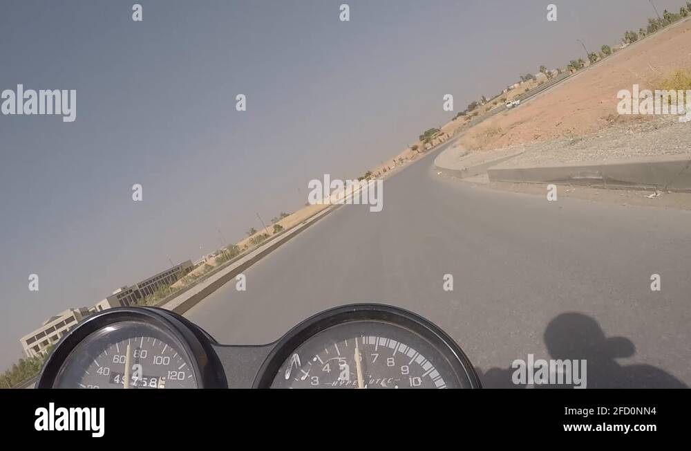 A harsh and an unsafe motorcycle turn in Erbil, Iraq. POV of the driver ...