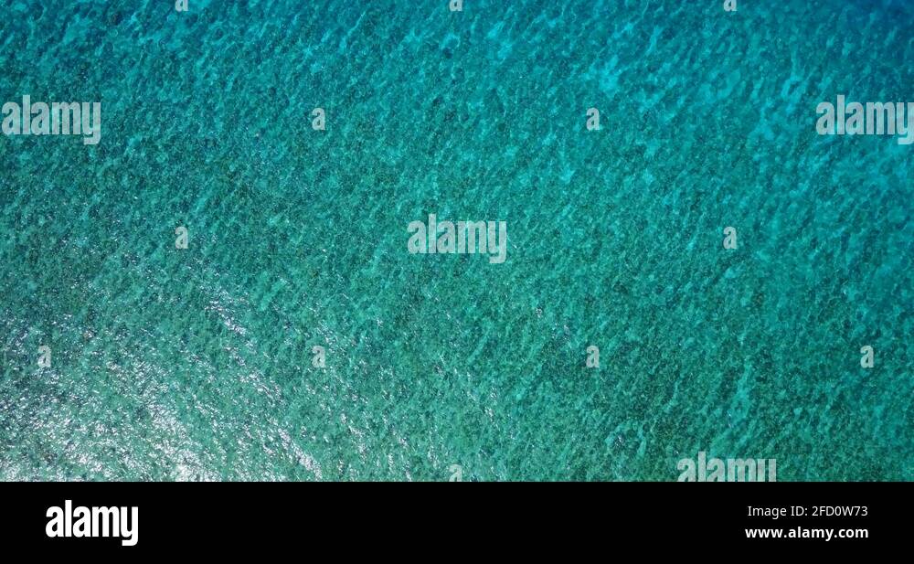 Beautiful sea texture with coral reefs and rocky seabed under turquoise ...