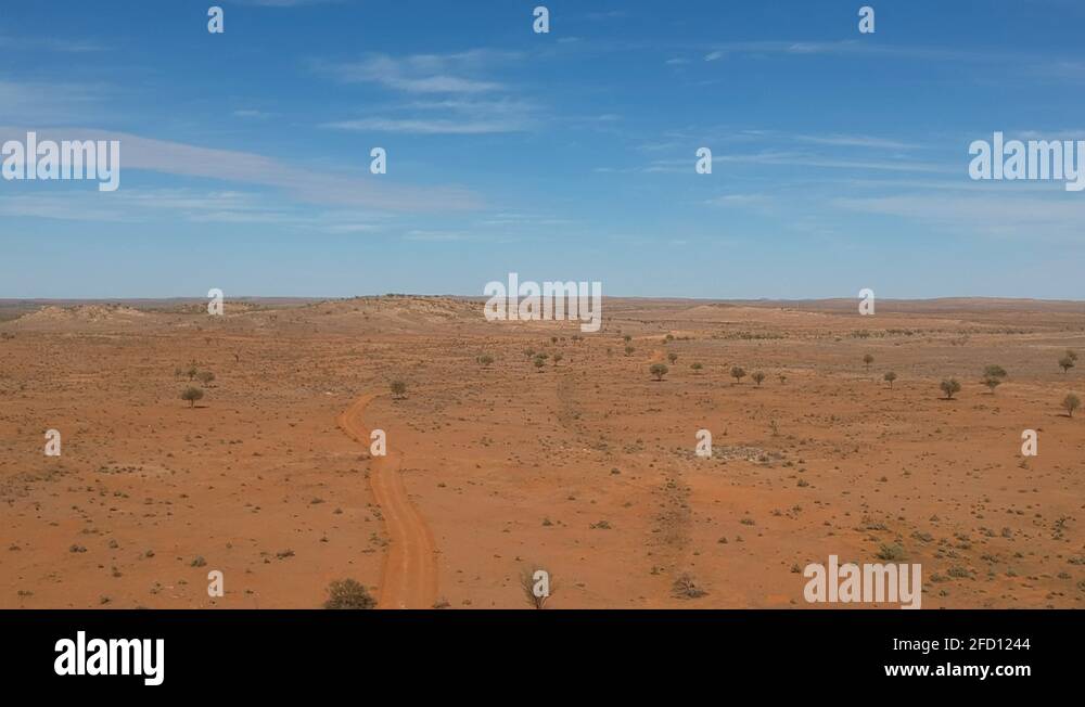 Desolate and abandoned, revealing a gate in the dry outback of ...