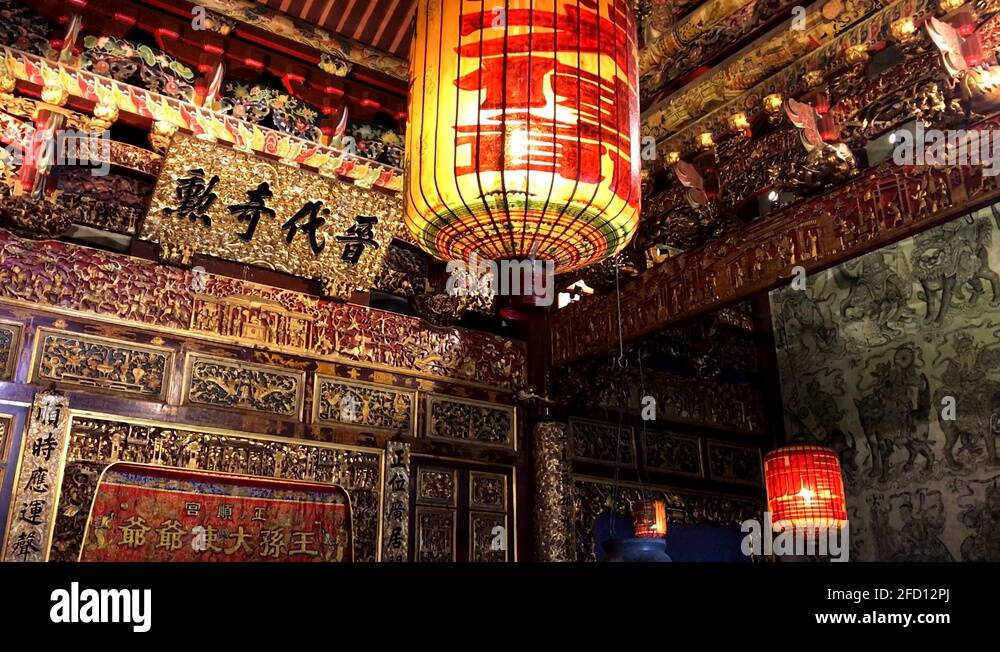 Chinese temple interior with traditional woodwork, gold and lanterns ...