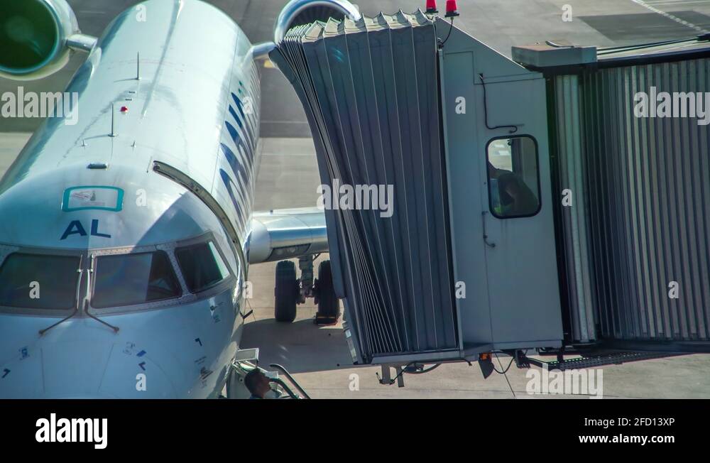 Opening of passenger boarding bridge/ jetbridge, to connect plane to ...