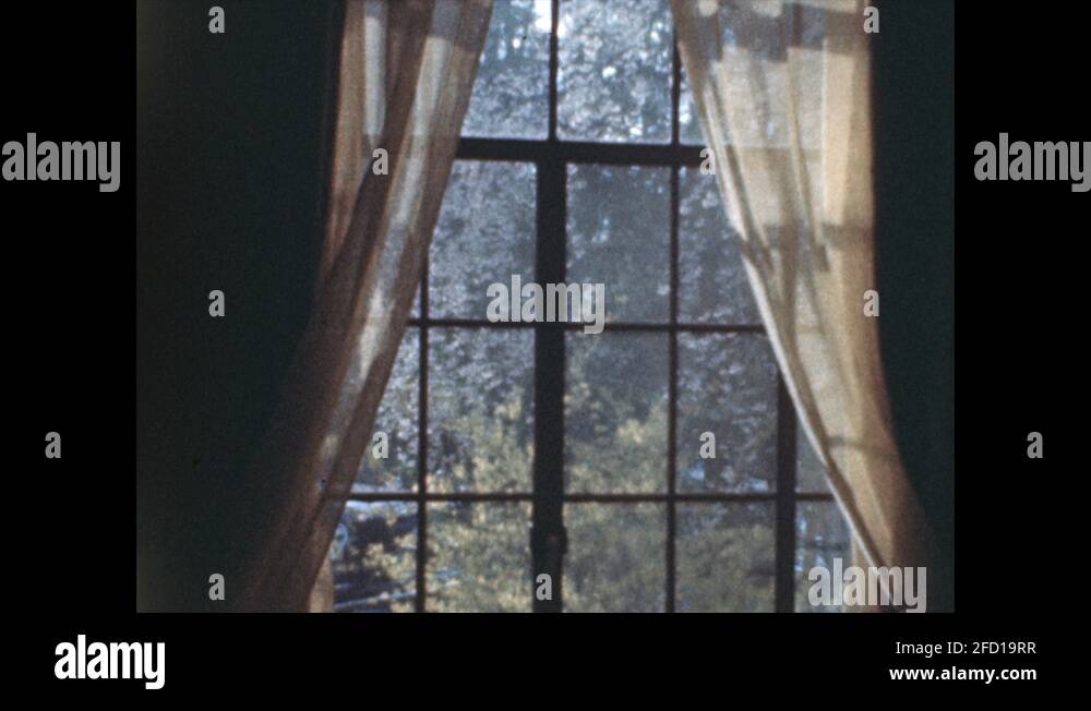 1940s: Looking out window of house. Looking out different window of ...
