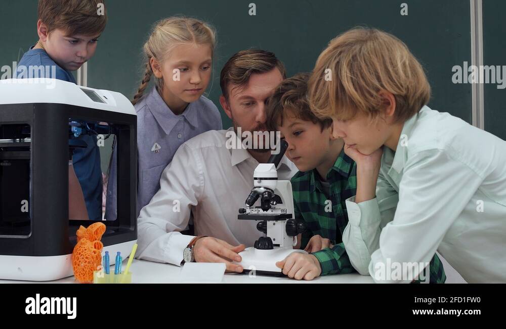 lesson in a modern school, a teacher and children's look into a ...