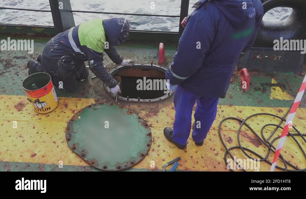 mechanics change pins of cargo tank hatch on oil tanker Stock Video ...