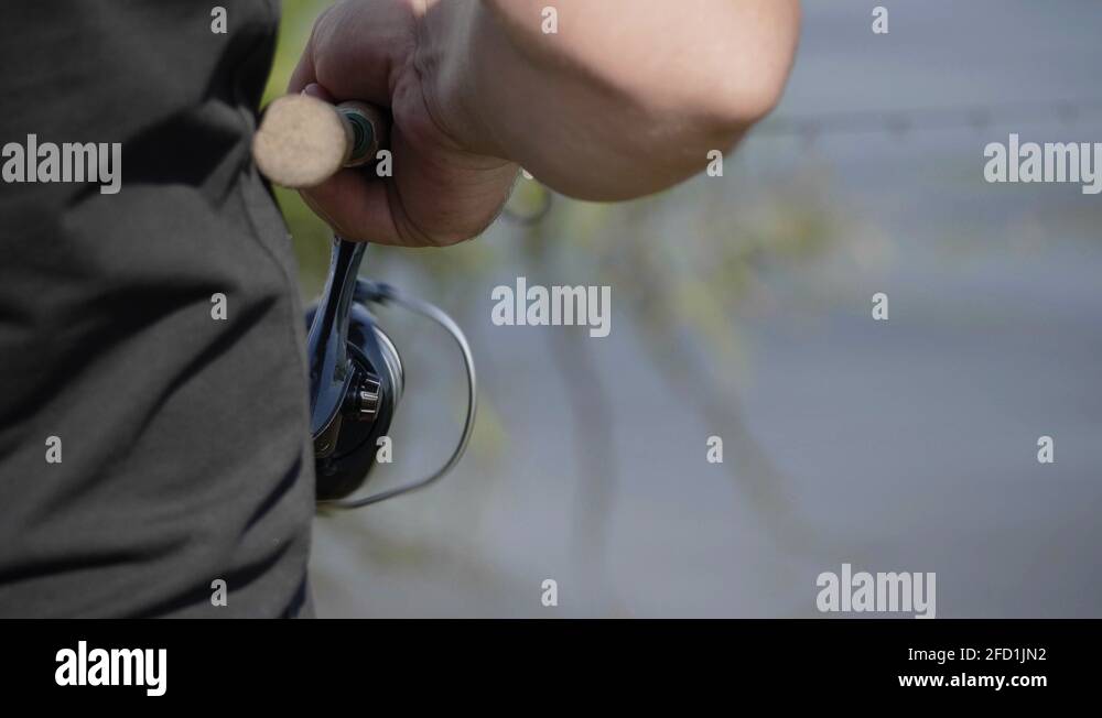 Male hand holding fishing rod and reeling the other hand Stock Video ...