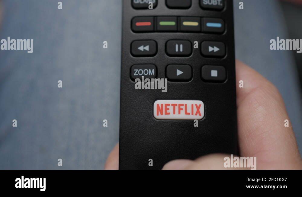 Netflix on TV Button a Remote Control. Close Up Woman With TV Remote ...