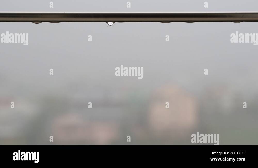 Rain water drops falling down from railing aluminium, transparent rain ...