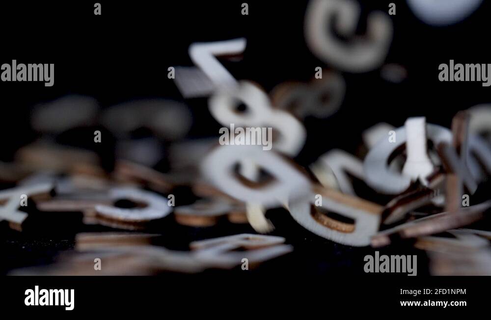Close-up conceptual shot of alphabet letters falling on a black ...
