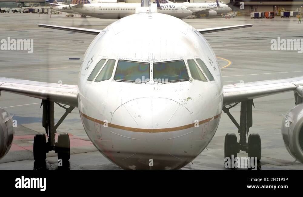 Close up front view of a Boeing jet being pushed back from a gate at ...
