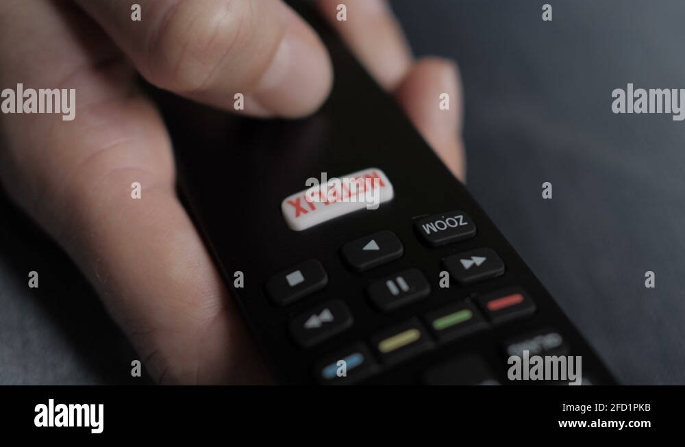 Netflix on TV Button a Remote Control. Close Up Woman With TV Remote ...