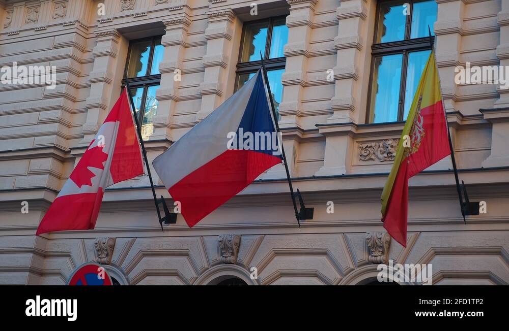 Wind blowing and waving the national flags of Czech Republic and Canada ...