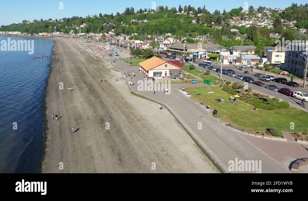 Drone footage of Alki Beach, sandy shoreline with bike path, trail and ...