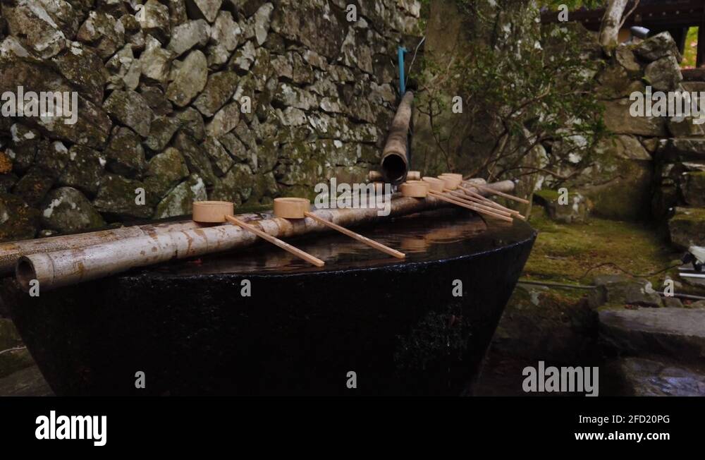 A continuous stream of water flowing into a bucket/water feature ...