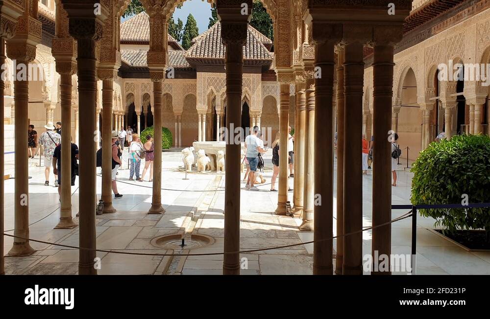 People walk through columns at Lions Court, Alhambra, Granada. Zoom in ...